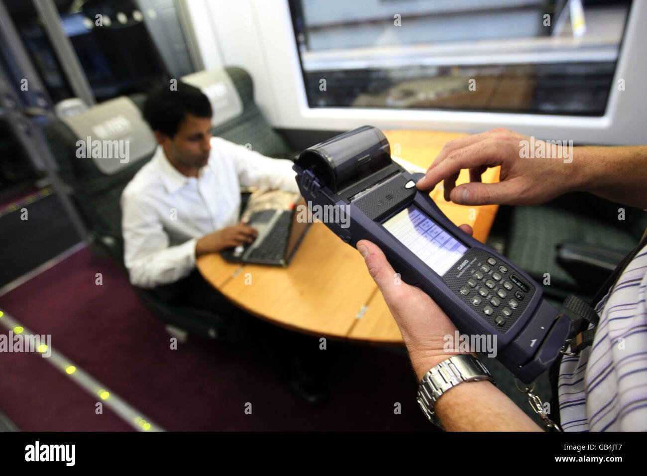 A conductor and passenger on a first class coach on the Heathrow ...