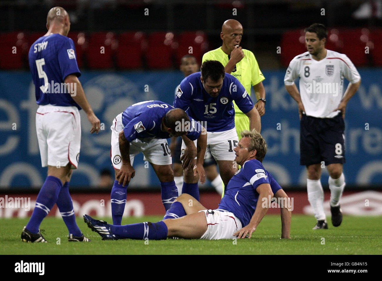 Celebrity Chef Gordon Ramsay is surrounded by team mates as he lies on ...