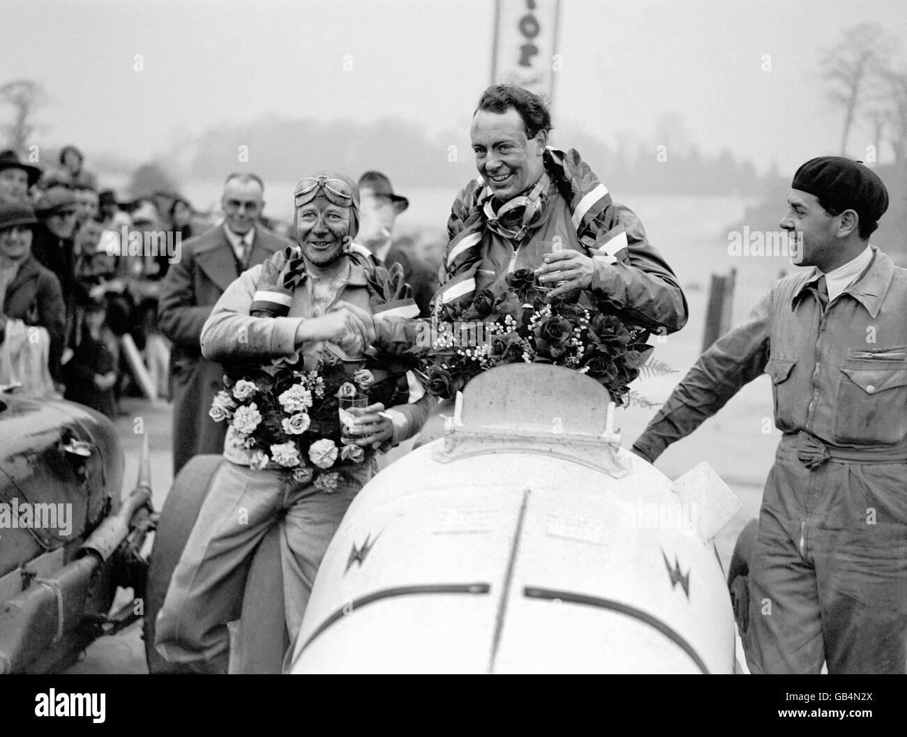 Race winner Whitney Straight, centre, shakes hands with runner up Brian ...