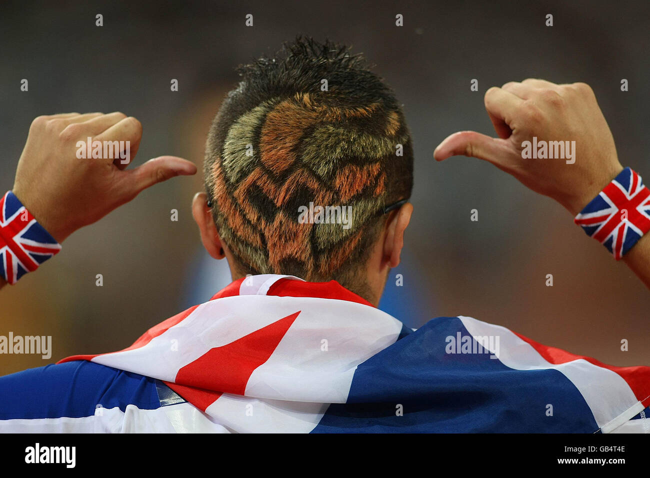 Great Britain's Ian Jones gesturing to his haircut after crossing the ...