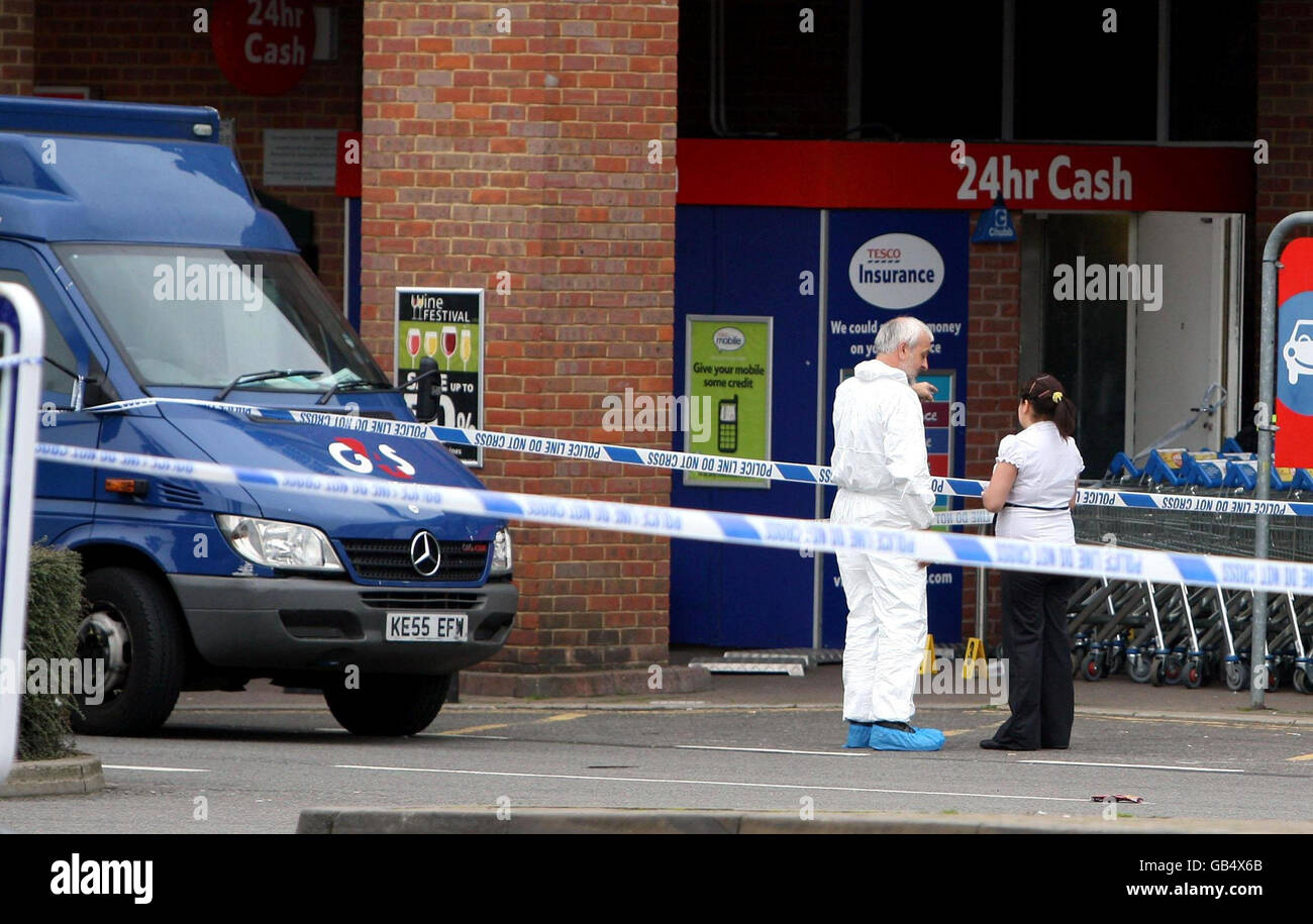 Police at the scene at a Tesco supermarket in Tring, Buckinghamshire ...