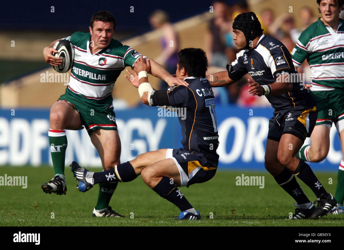 Leicester's Aaron Mauger hands off Worcester's Loki Crichton during the ...