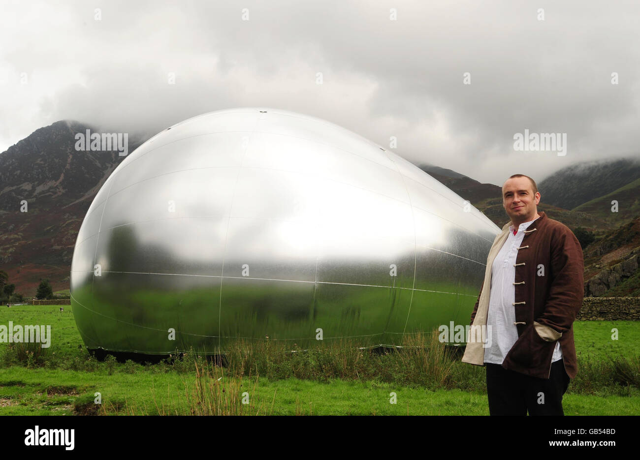 Artist Steve Messam stands alongside 'Drop' a giant reflective ...