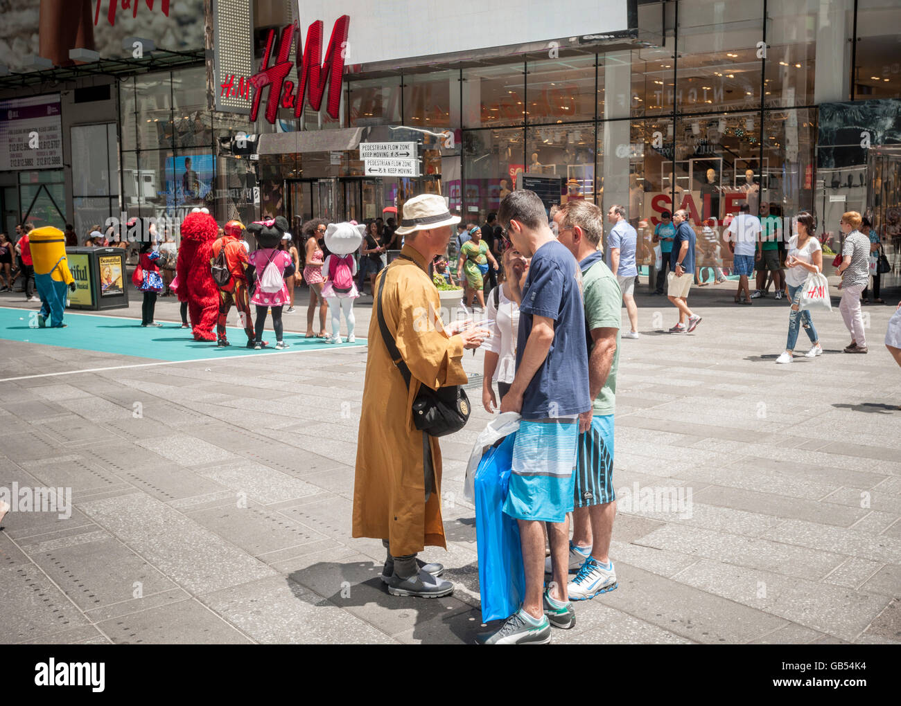 A man wearing an orange robe purporting to be a "Buddhist Monk" raising ...