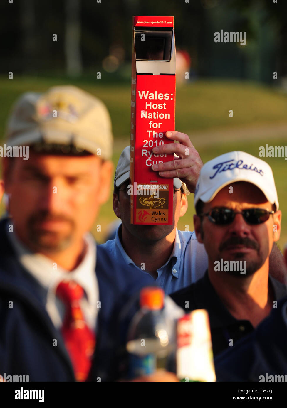 A Golf fan is able to watch the action in the large crowds with a ...