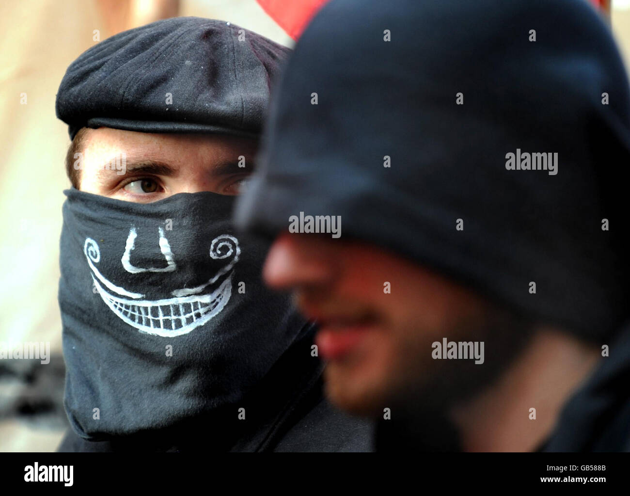 Protesters cover their faces during an anti-war march in Manchester ...