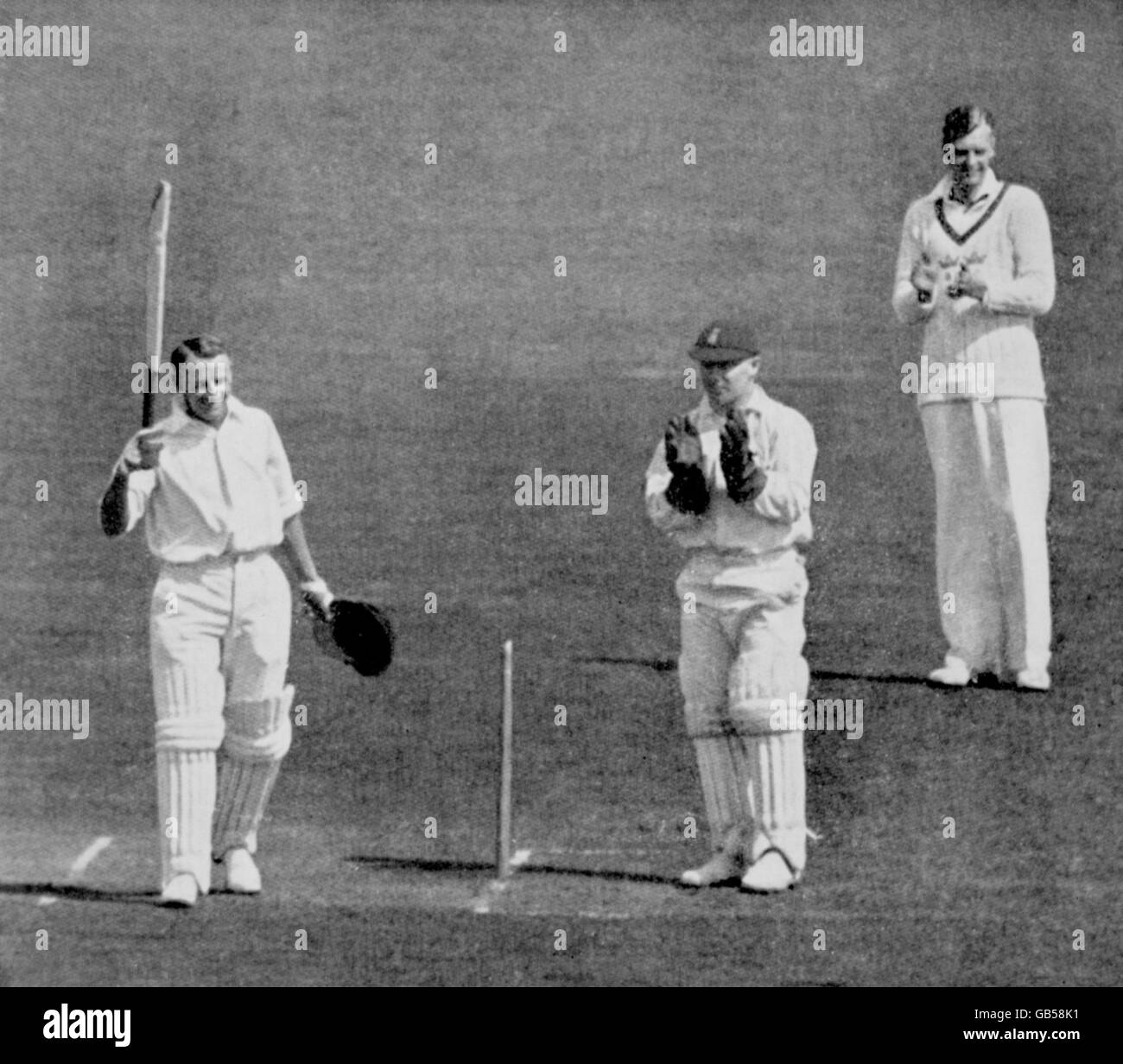 (L-R) Australia's Don Bradman acknowledges the cheers of the crowd ...
