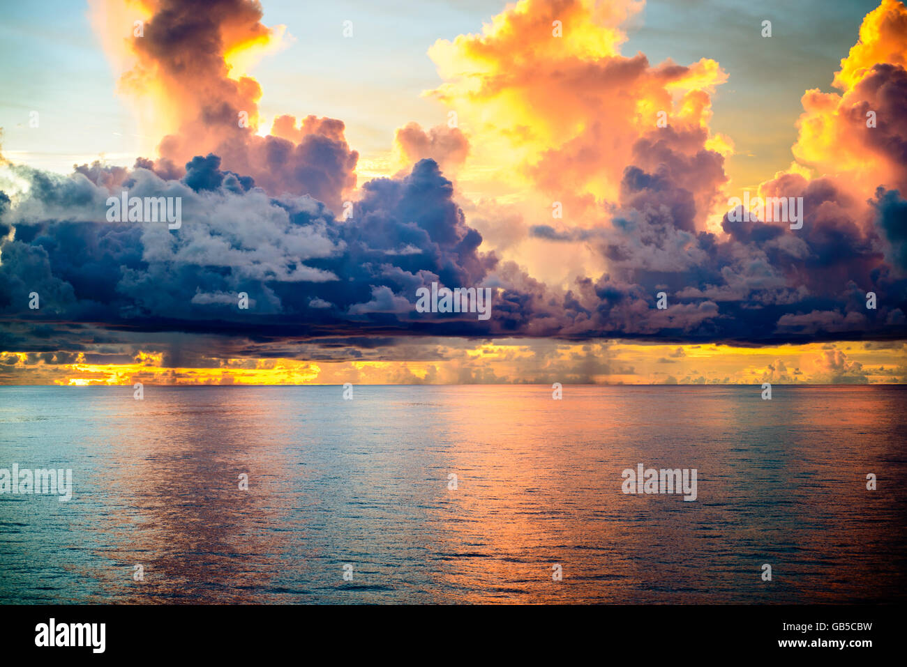 A dark sky with an amazing array of storm clouds with calm seas. Image ...