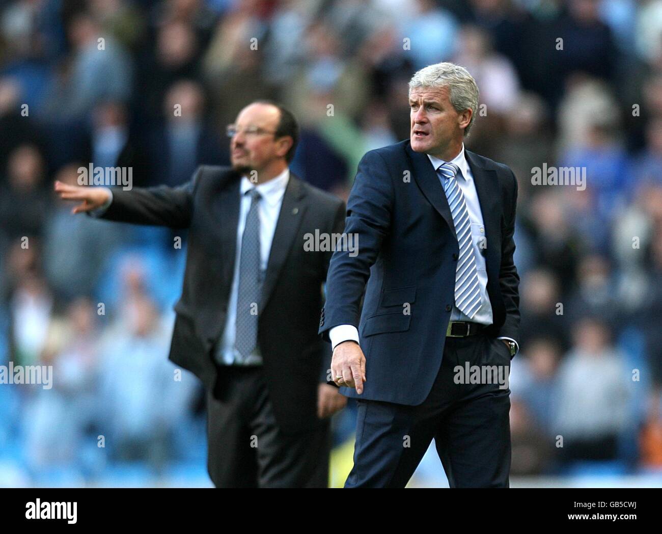 Manchester City manager Mark Hughes (right) and Liverpool manager ...