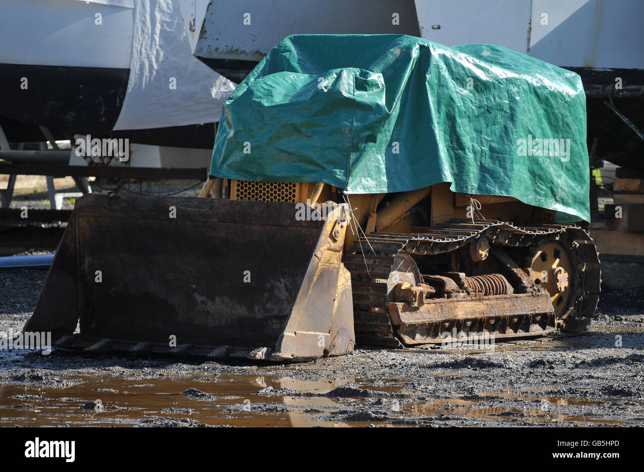 Rusty Unused Digger Covered by Green Plastic Stock Photo - Alamy