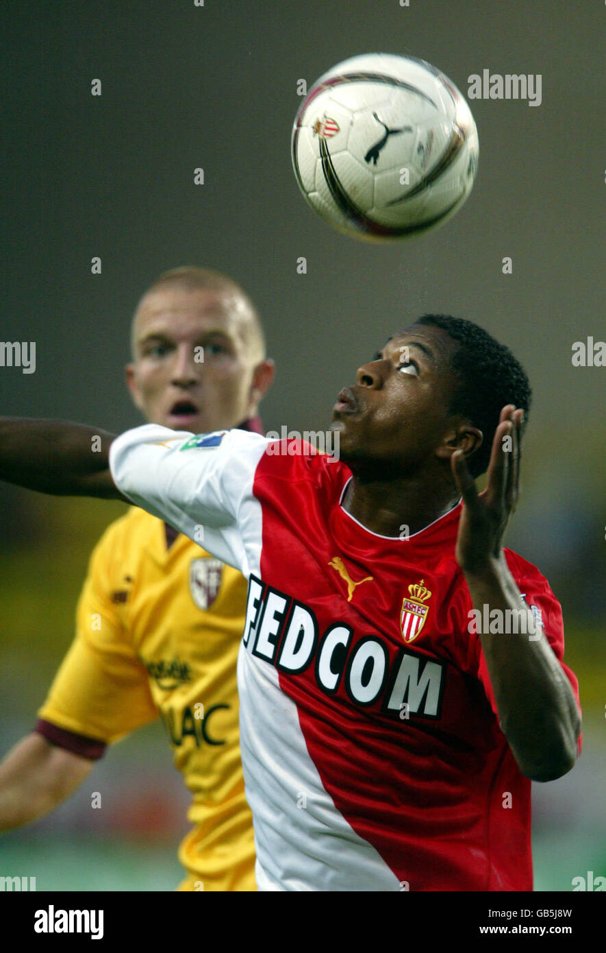 Monaco's Patrice Evra juggles the ball on his head watched by Metz's ...