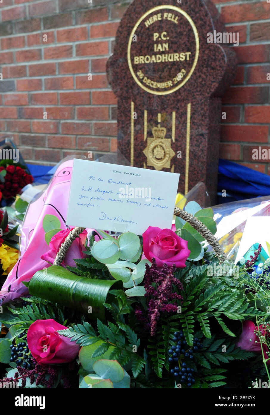 A memorial dedicated to PC Ian Broadhurst is surrounded by flowers ...