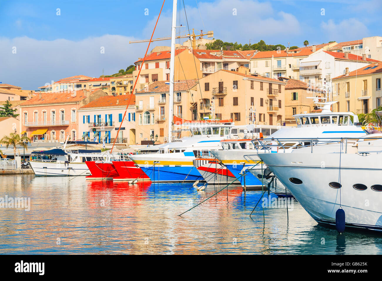 A view of Calvi port with colorful houses and boats, Corsica island ...