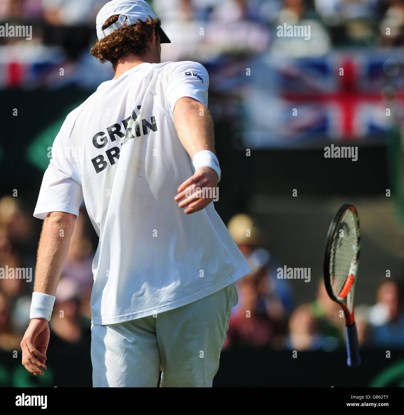 Great Britain's Andy Murray bounces his racquet onto the turf during ...