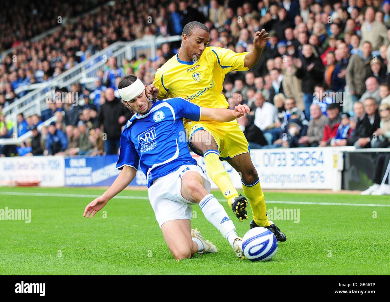 Leeds United's Fabian Delph and Peterborough United's George Boyd ...