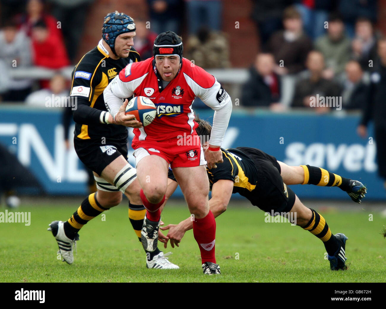 Gloucester's Alasdair Dickinson evades the tackle of Wasps' Rob Hoadley ...