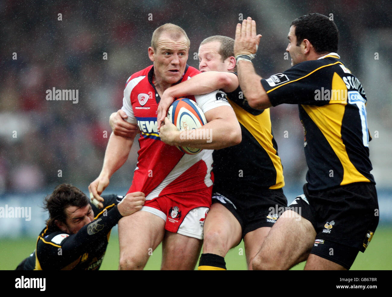 Gloucester's Mike Tindall is tackled by Wasps Tom Voyce, Dave Walder ...