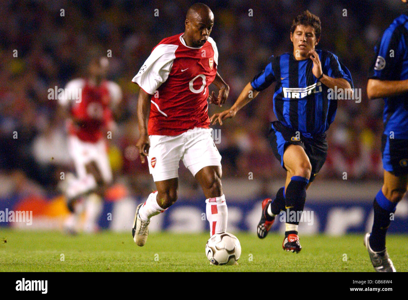 Arsenal's Sylvain Wiltord is chased by Inter Milan's Emre Belozoglu (r ...