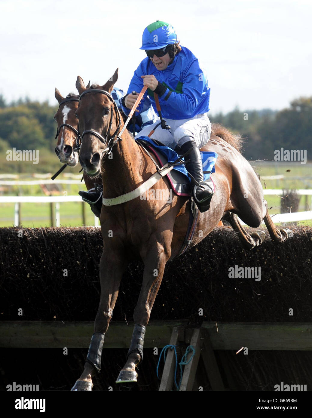Exmoor Ranger and jockey Christian Williams jump the last fence and go ...