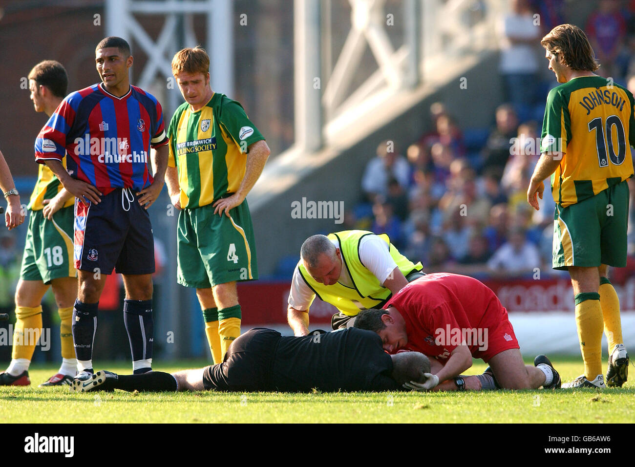 Referee Paul Danson receives treatment from the Crystal Palace physio ...