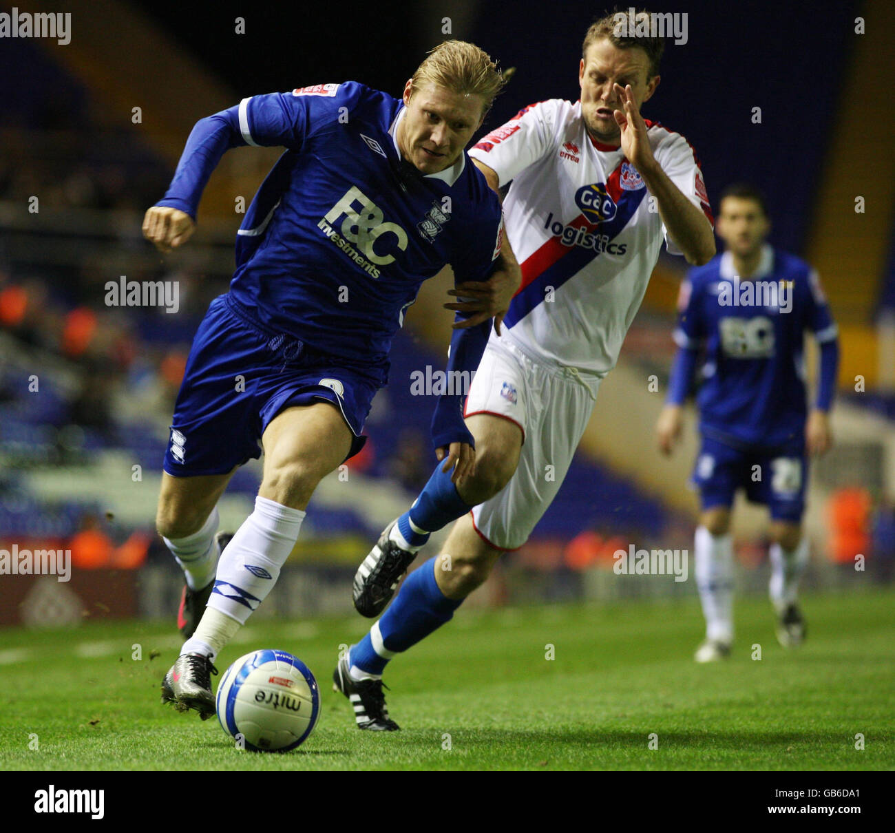 Birmingham City's Garry O'Connor (left) holds off a challenge from ...
