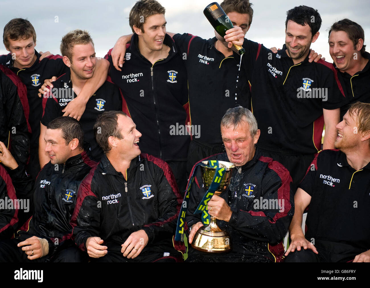 Durham coach Geoff Cook is covered in champagne as his team celebrate ...