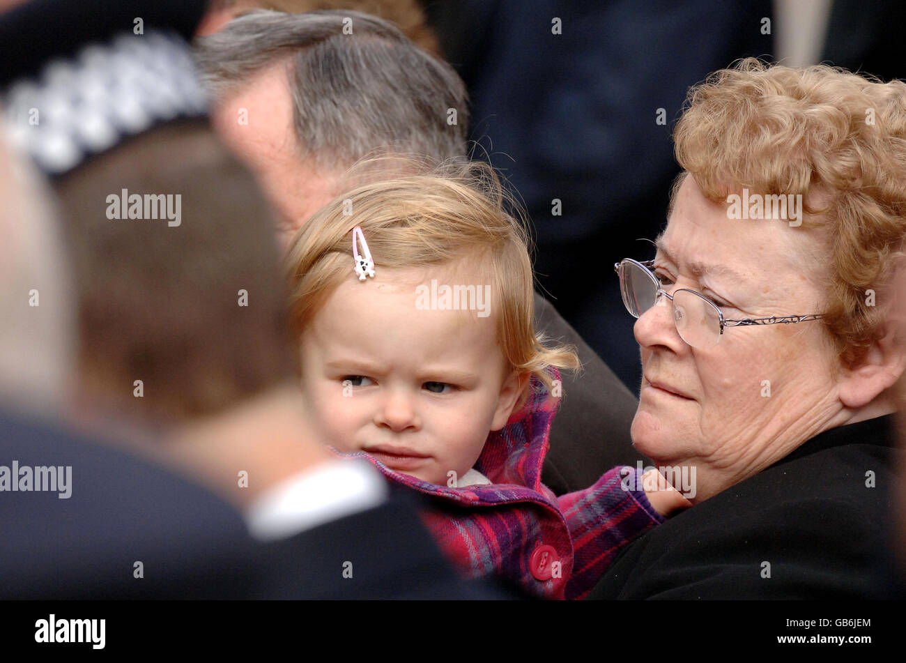 Two-year-old Maggie Henry sits with her grandmother, Margaret, at a ...