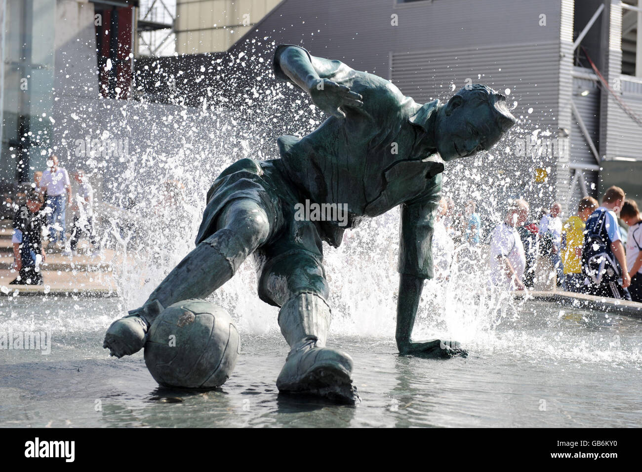 A statue of Preston North End's Tom Finney splashing through a puddle ...