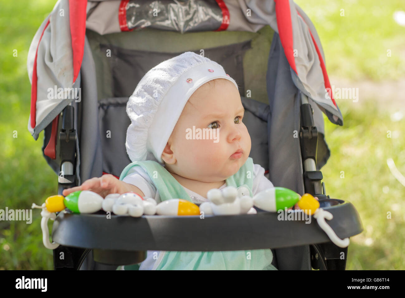 little girl sitting in a baby carriage Stock Photo - Alamy