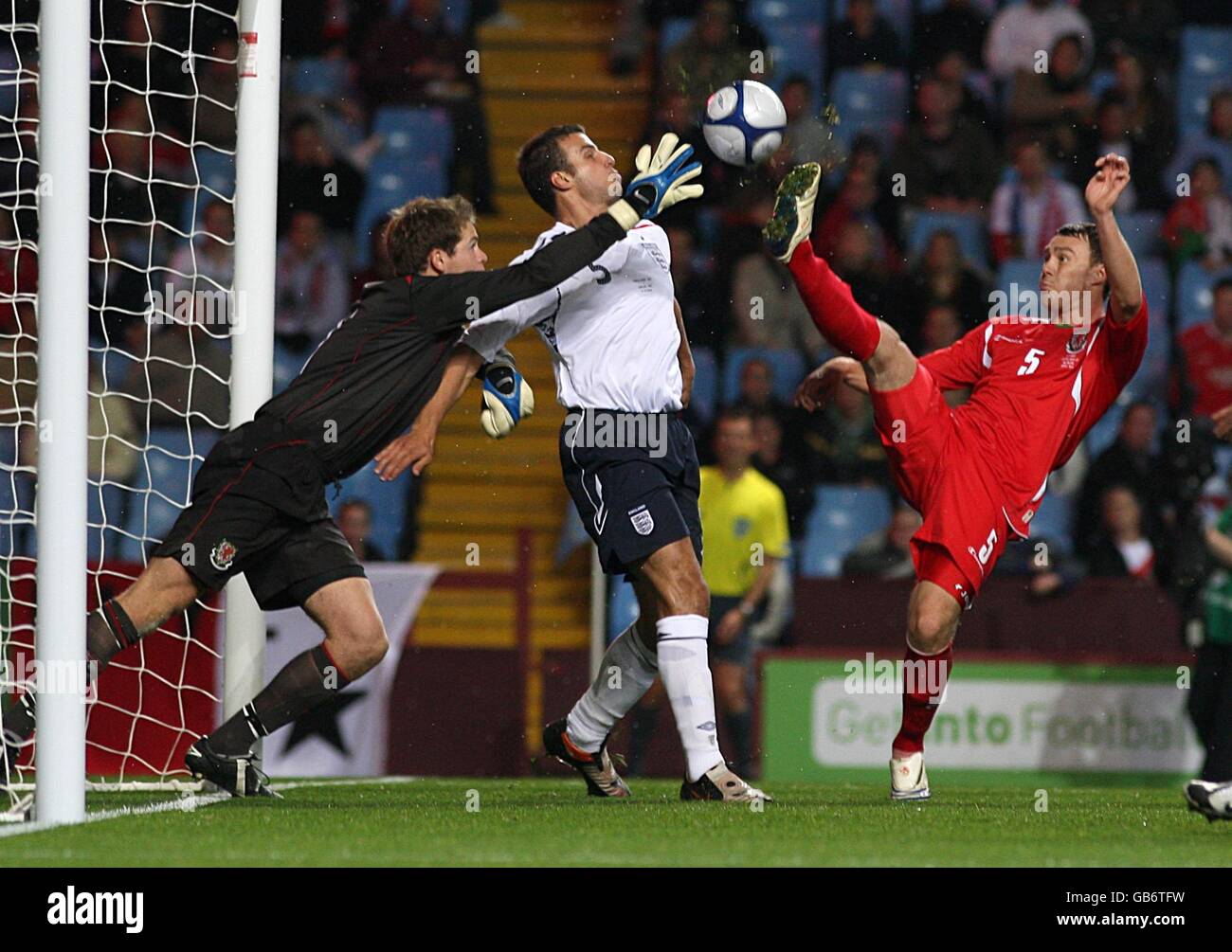 England's Steven Taylor (c) battle's for the ball with Wales Darcey ...