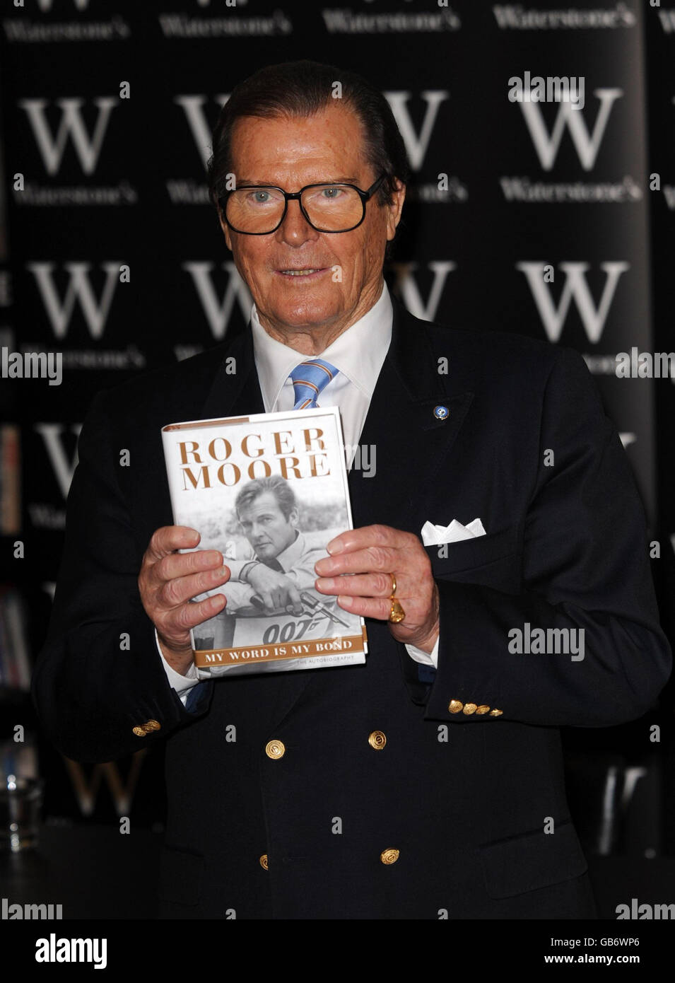 Sir Roger Moore poses for photographs prior to signing copies of his ...