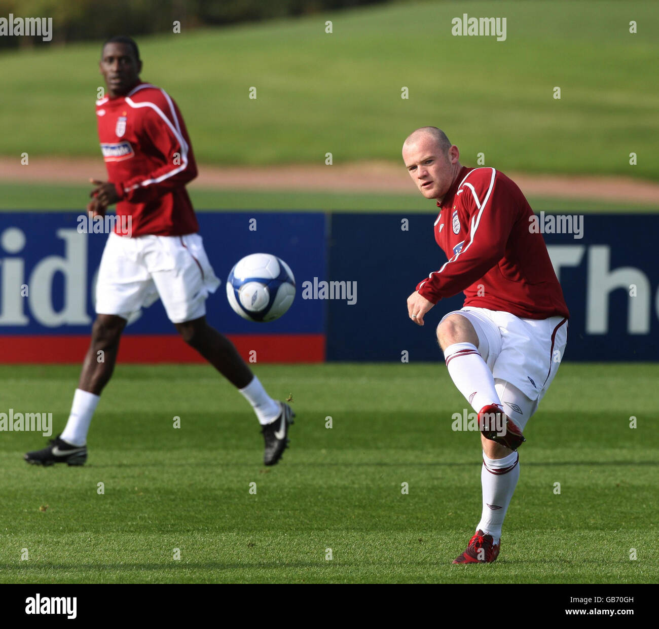 England's Wayne Rooney showing off his new hair cut during training ...