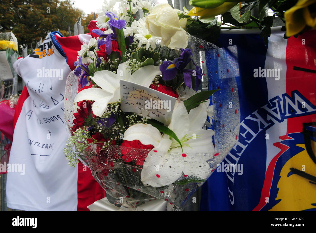 Floral tributes are left on the gates of Belle Vue in Wakefield, the ...