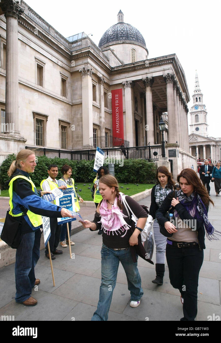 Striking workers from the National Gallery hand pamphlets to passersby ...