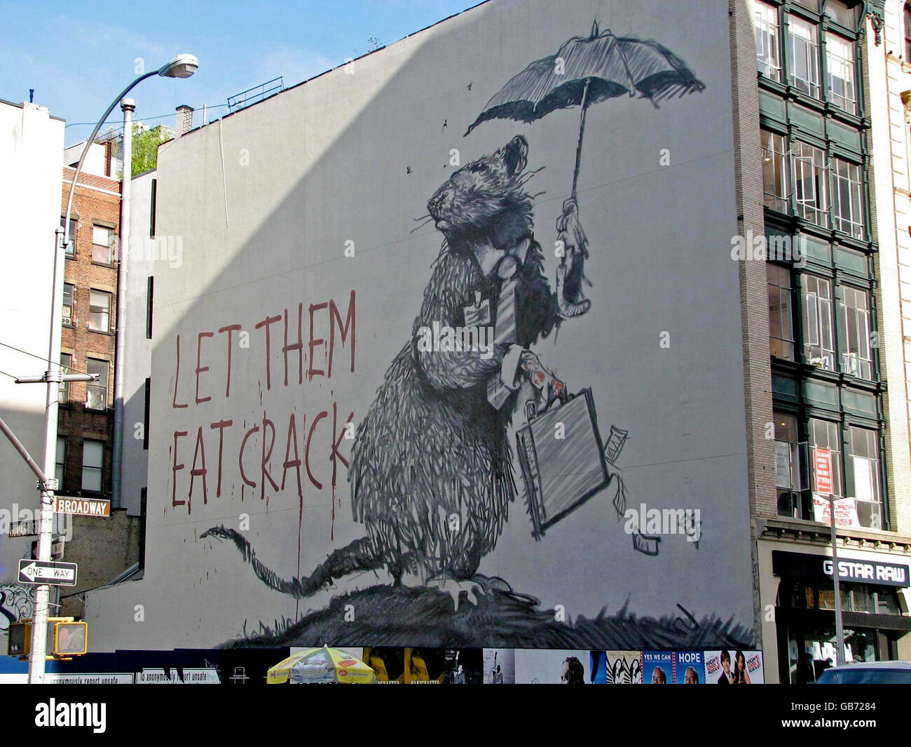 A large mural of a rat wearing a tie and carrying a briefcase on a wall ...