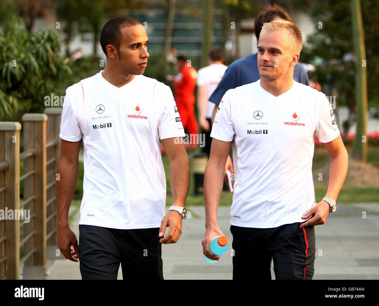 Lewis Hamilton (left) walks through the paddock with team mate Heikki ...