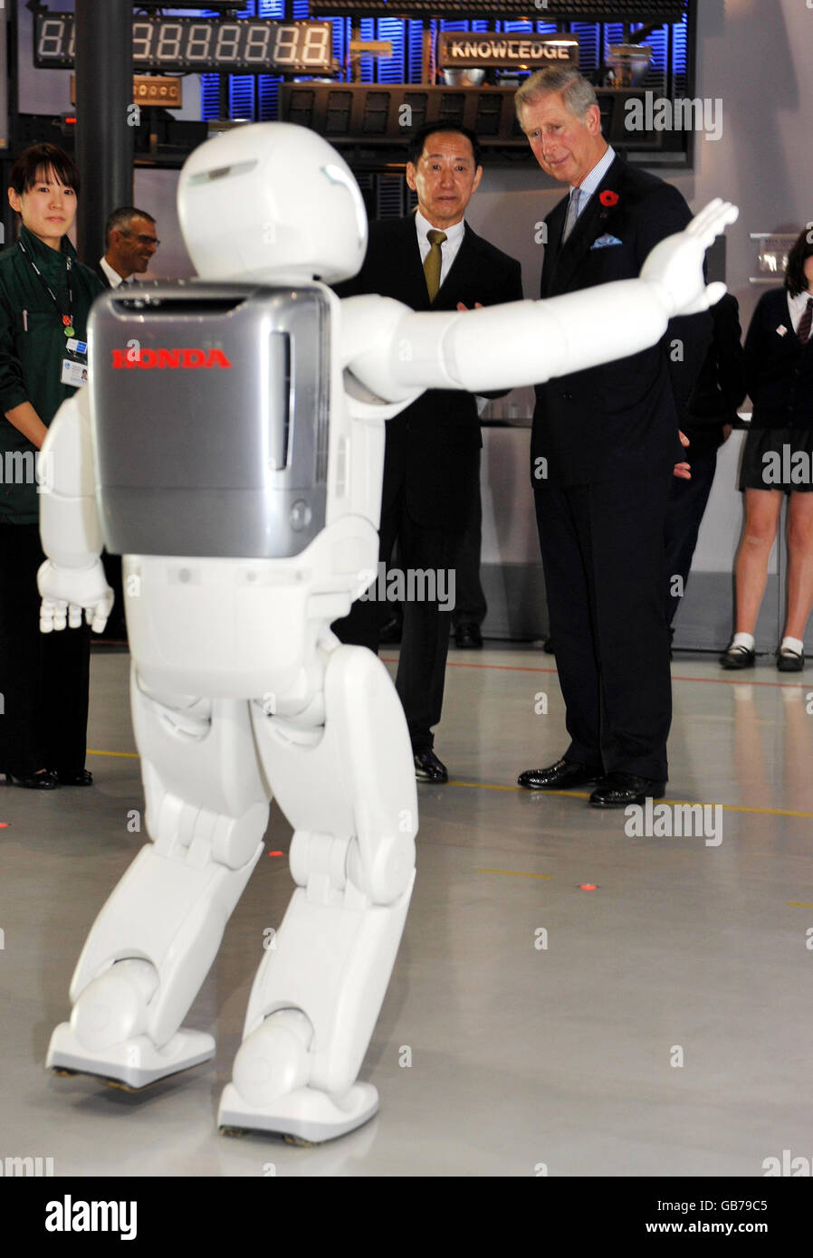 The Prince of Wales watches the dancing of Asimo the Robot, during a ...