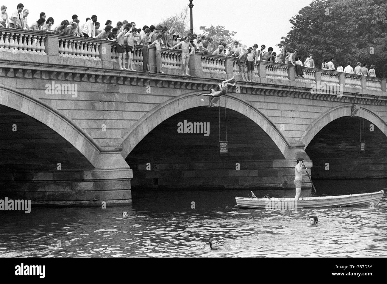 Some enterprising bathers use the bridge at the Serpentine as a diving ...