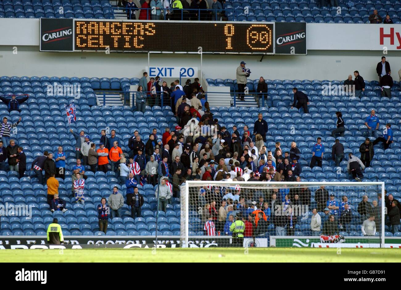 Rangers fans leave the stadium after losing to Celtic with the score on ...