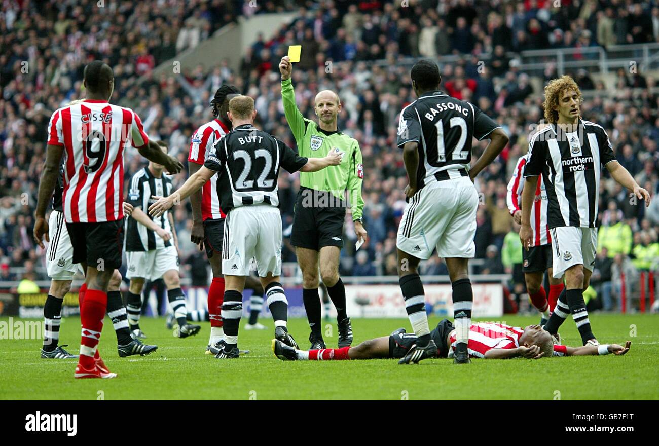 Newcastle United's Nicky Butt is shown a yellow card by referee Mike ...