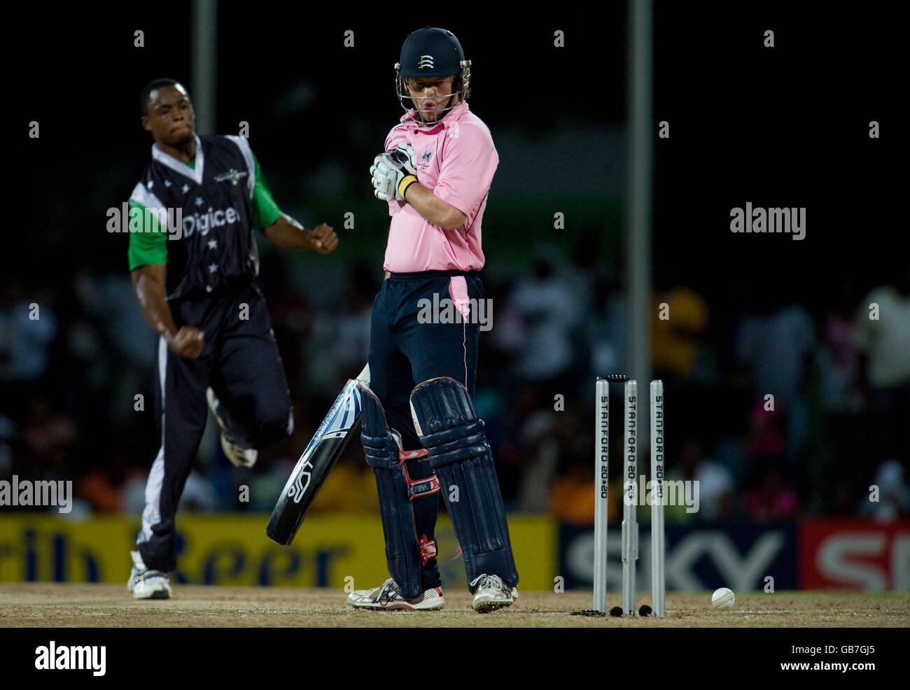 Middlesex's Ed Joyce is bowled by Stanford Superstars' Daren Powell ...
