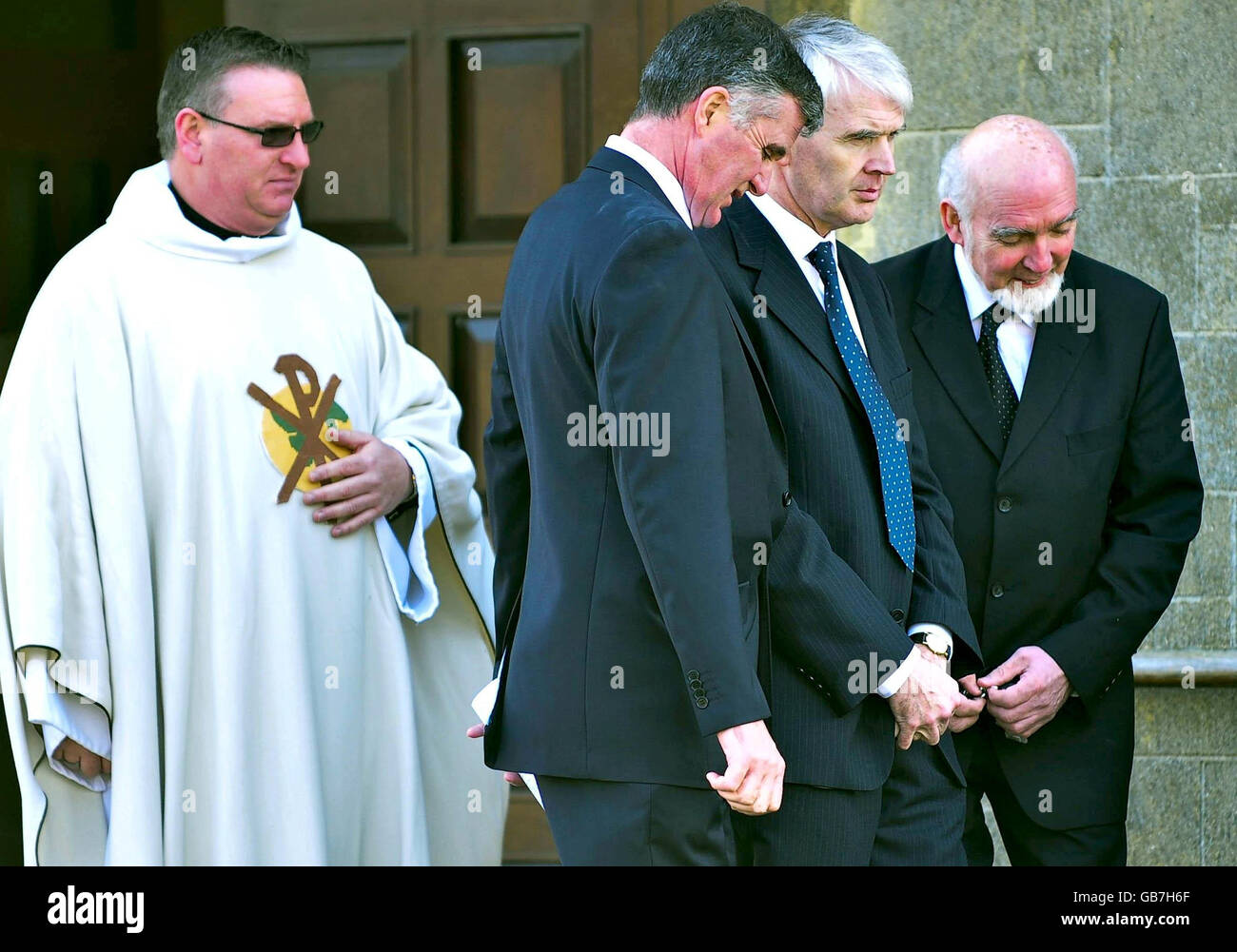 Richard O'Kennedy, second right, leaves a requiem mass held at Holy ...