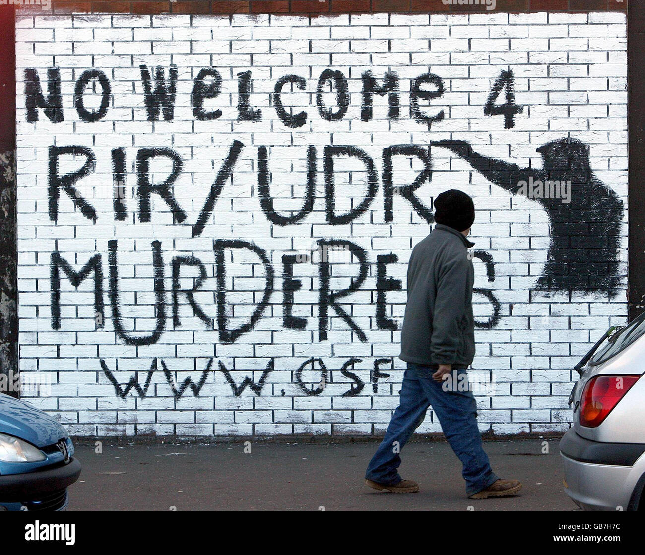 A man walks past graffiti protesting against the Armed Forces ...