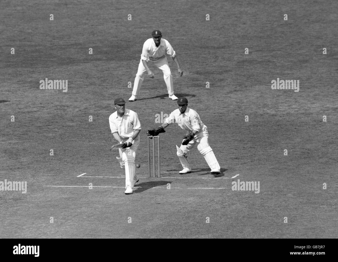 Yorkshire's Wilfred Rhodes puts a ball from Surrey bowler Percy Fender ...