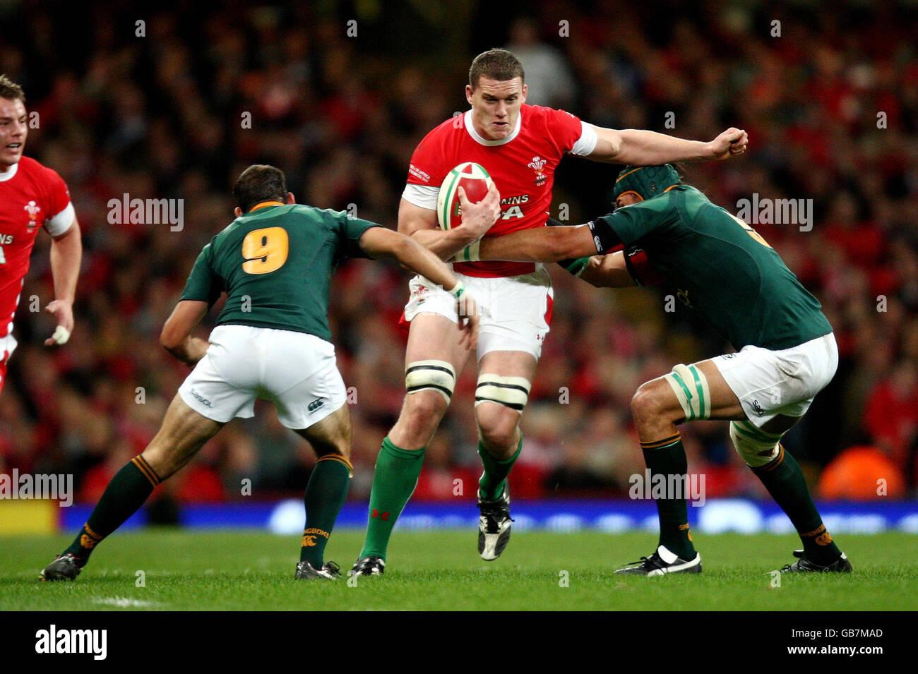 Ian Evans of Wales is tackled by Victor Matfield and Fourie Du Preez of ...