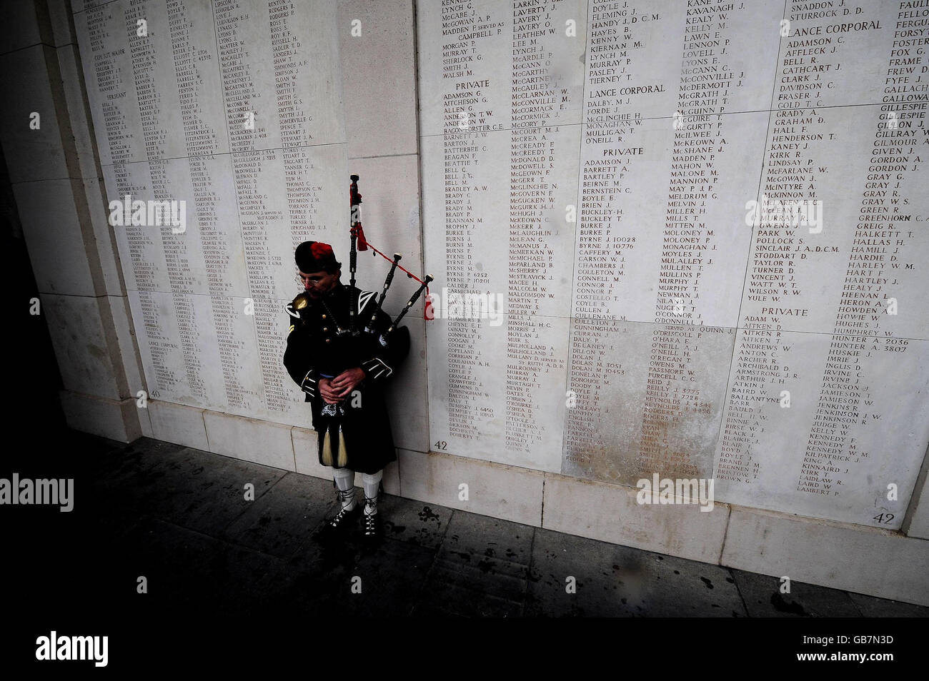 A Piper plays a lament in front of the names of thousands of British ...