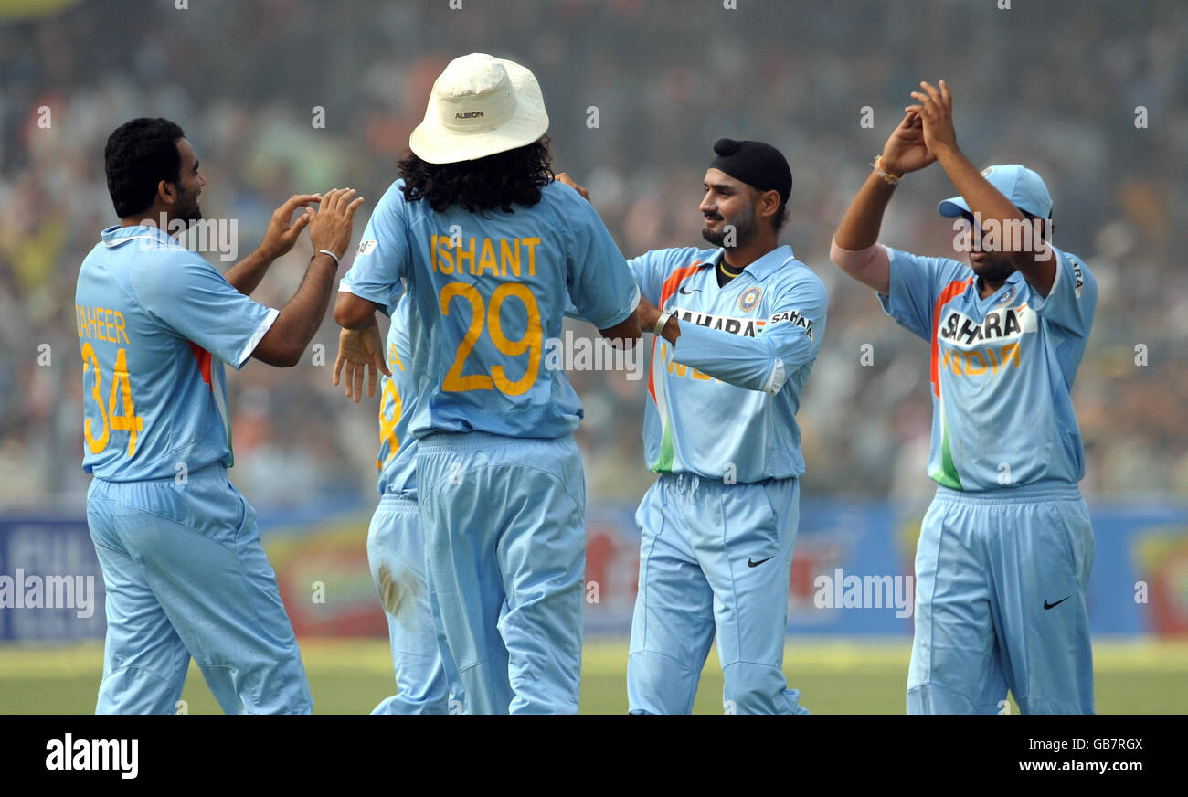 India celebrate as Kevin Pietersen is caught by Zaheer Khan for 14 ...