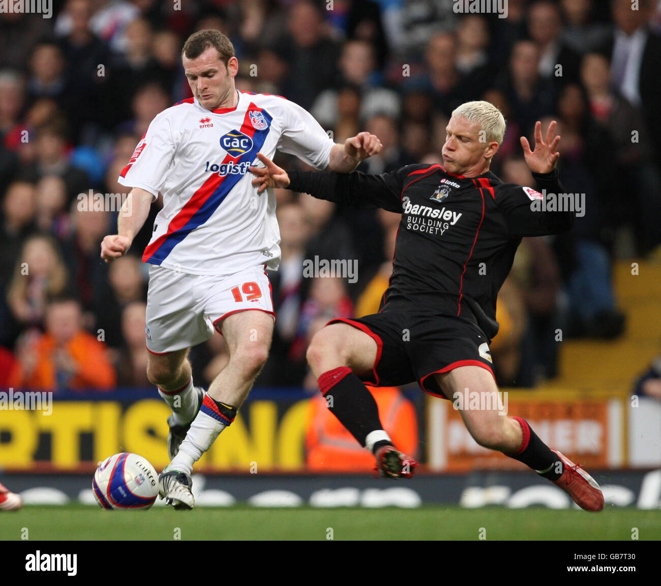 Crystal Palace's Craig Beattie and Barnsley's Bobby Hassell tussle for ...
