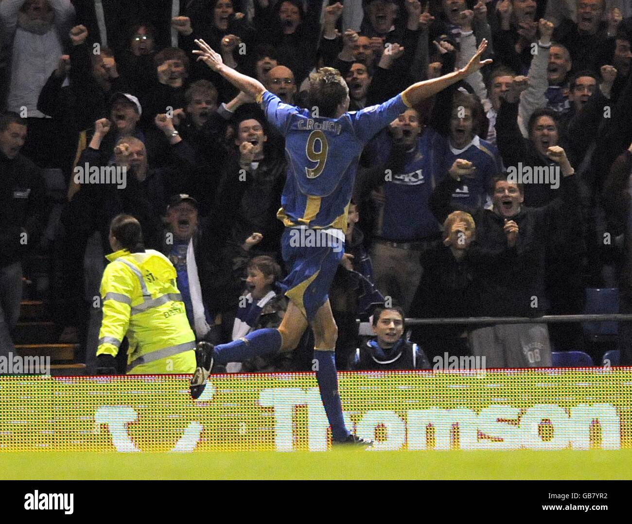 Portsmouth's Peter Crouch celebrates scoring the first goal of the game ...