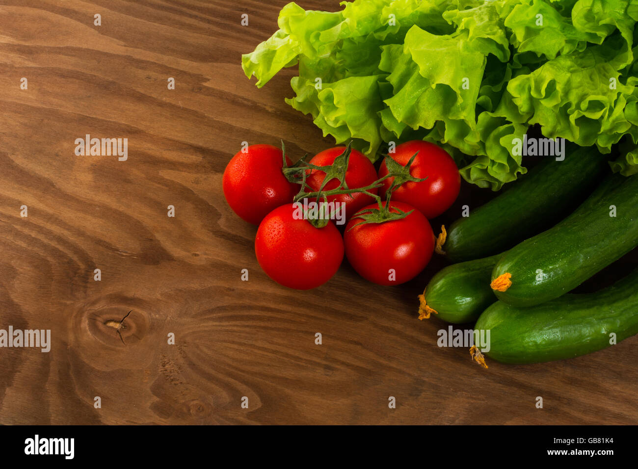 Cucumber and cherry tomato on wooden table Tomato. Cucumber. Ripe ...